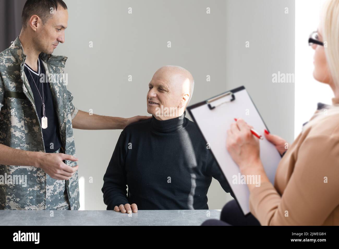 Psychologist making notes during therapy session with soldier, PTSD ...