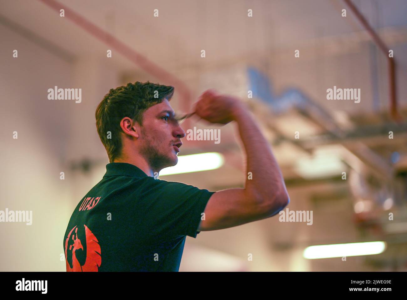Low angle of darts player aiming with the arrow Stock Photo - Alamy