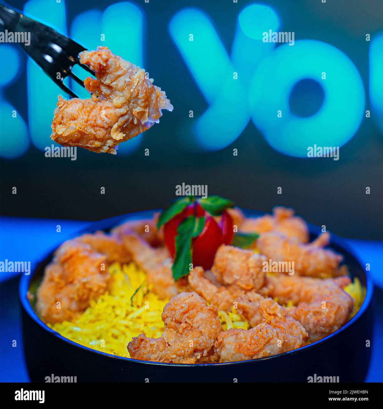 A closeup shot of Indian dish rice with fish served on a plate with a ...