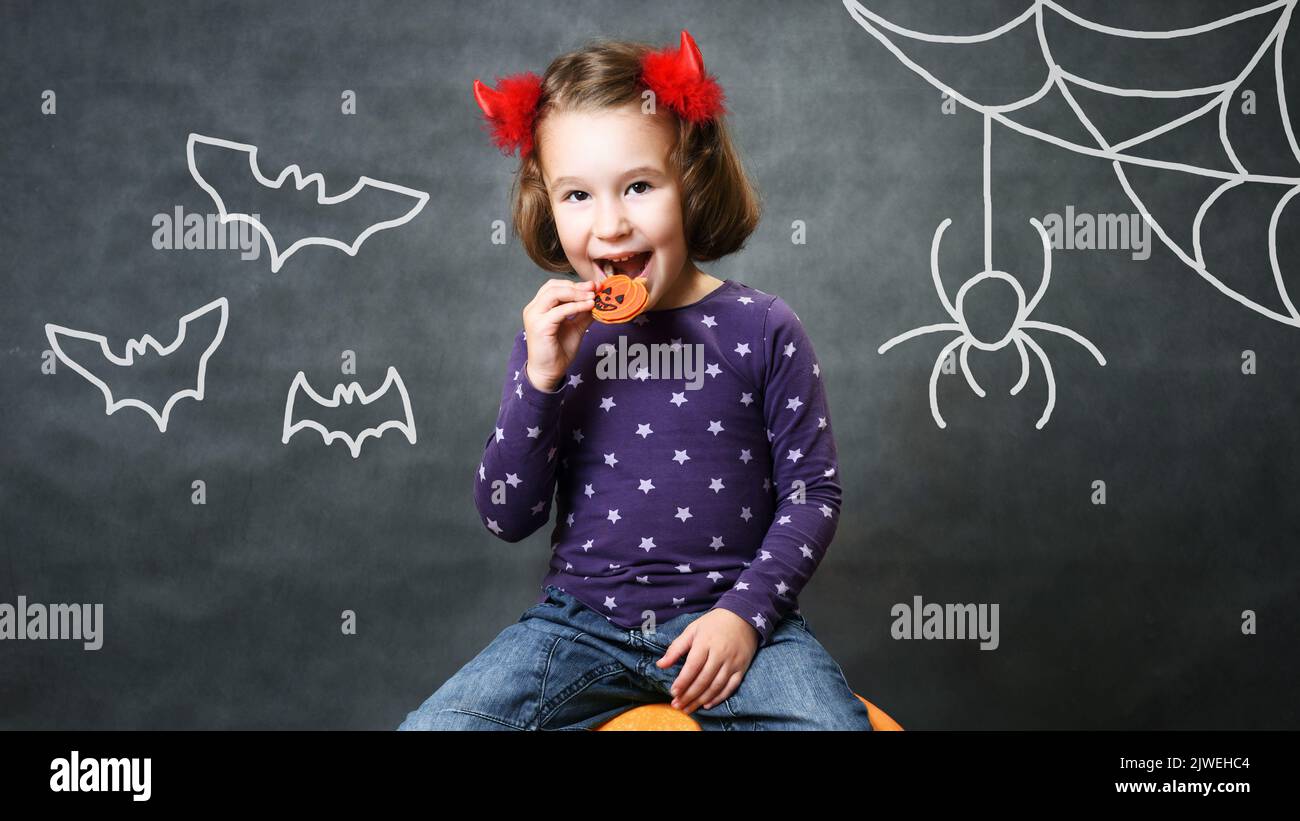 Kid in Halloween costume horns having fun, adorable happy child smiles ...