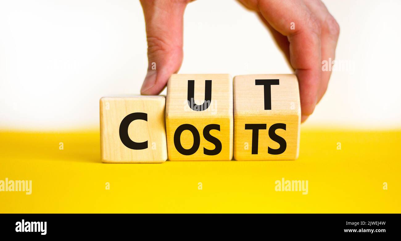 Cut costs symbol. Concept words Cut costs on wooden cubes. Businessman ...