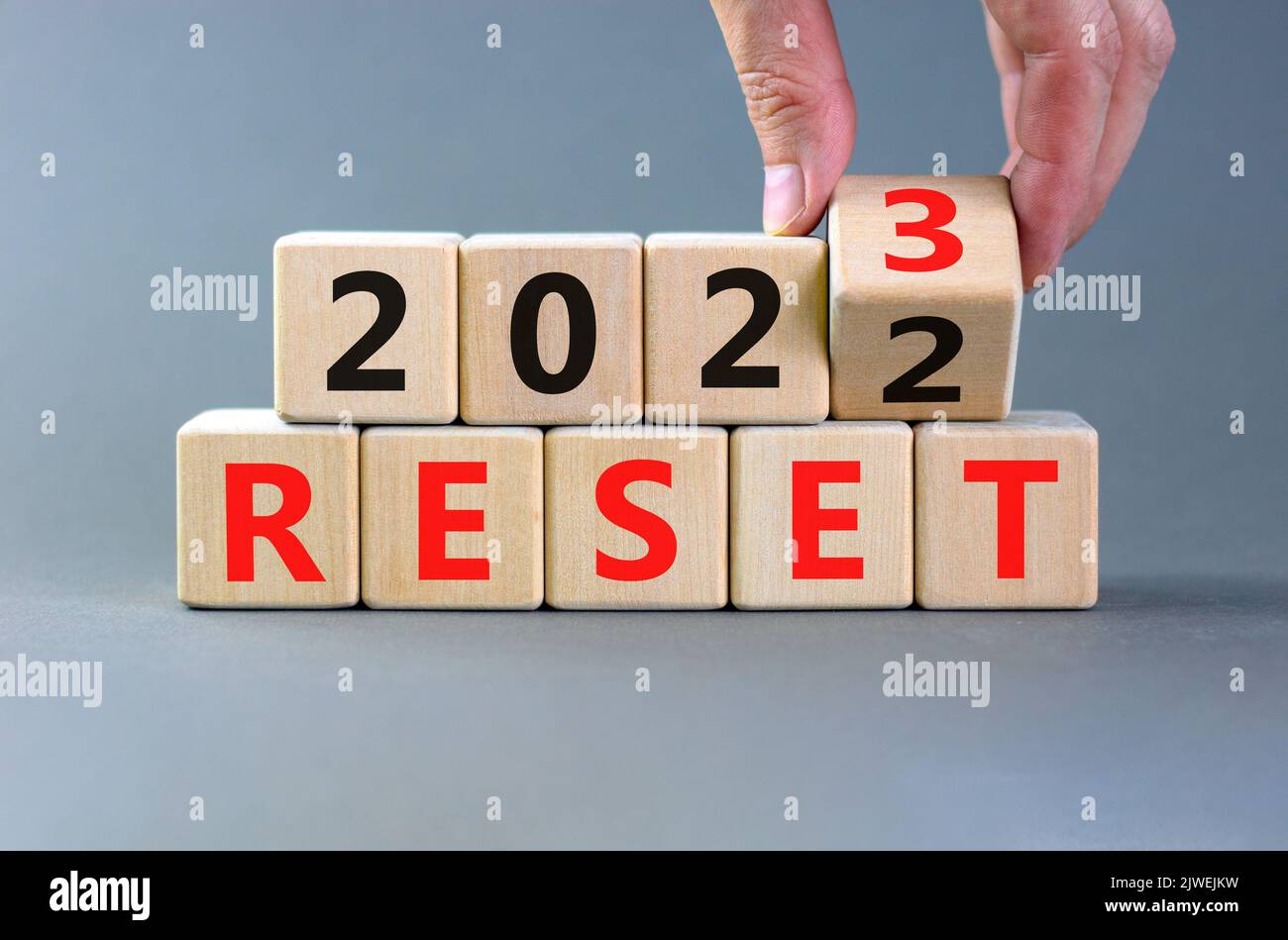 2023 reset new year symbol. Businessman turns a wooden cube and changes ...