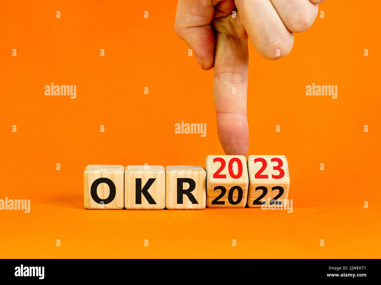 OKR, objectives and key results symbol. Businessman turns cubes with words OKR 2022 and OKR 2023 ...
