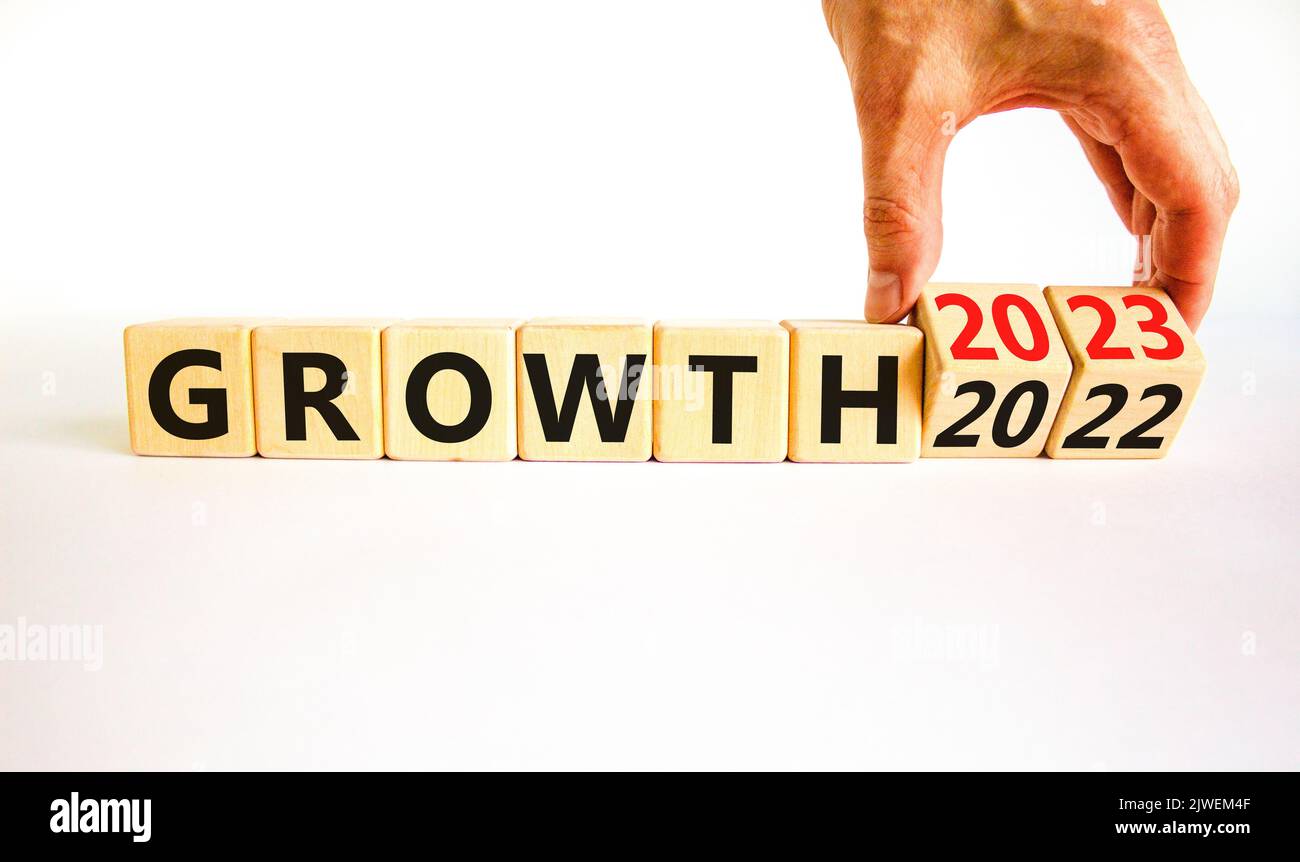 Planning 2023 growth new year symbol. Businessman turns a wooden cube ...