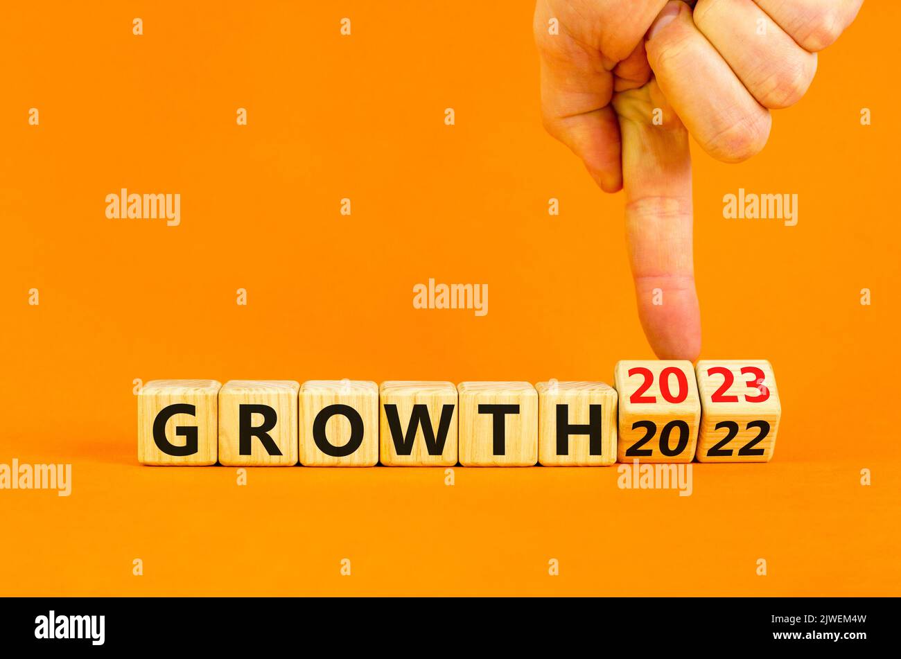 Planning 2023 growth new year symbol. Businessman turns a wooden cube ... Planning 2023 growth new year symbol. Businessman turns a wooden cube ...