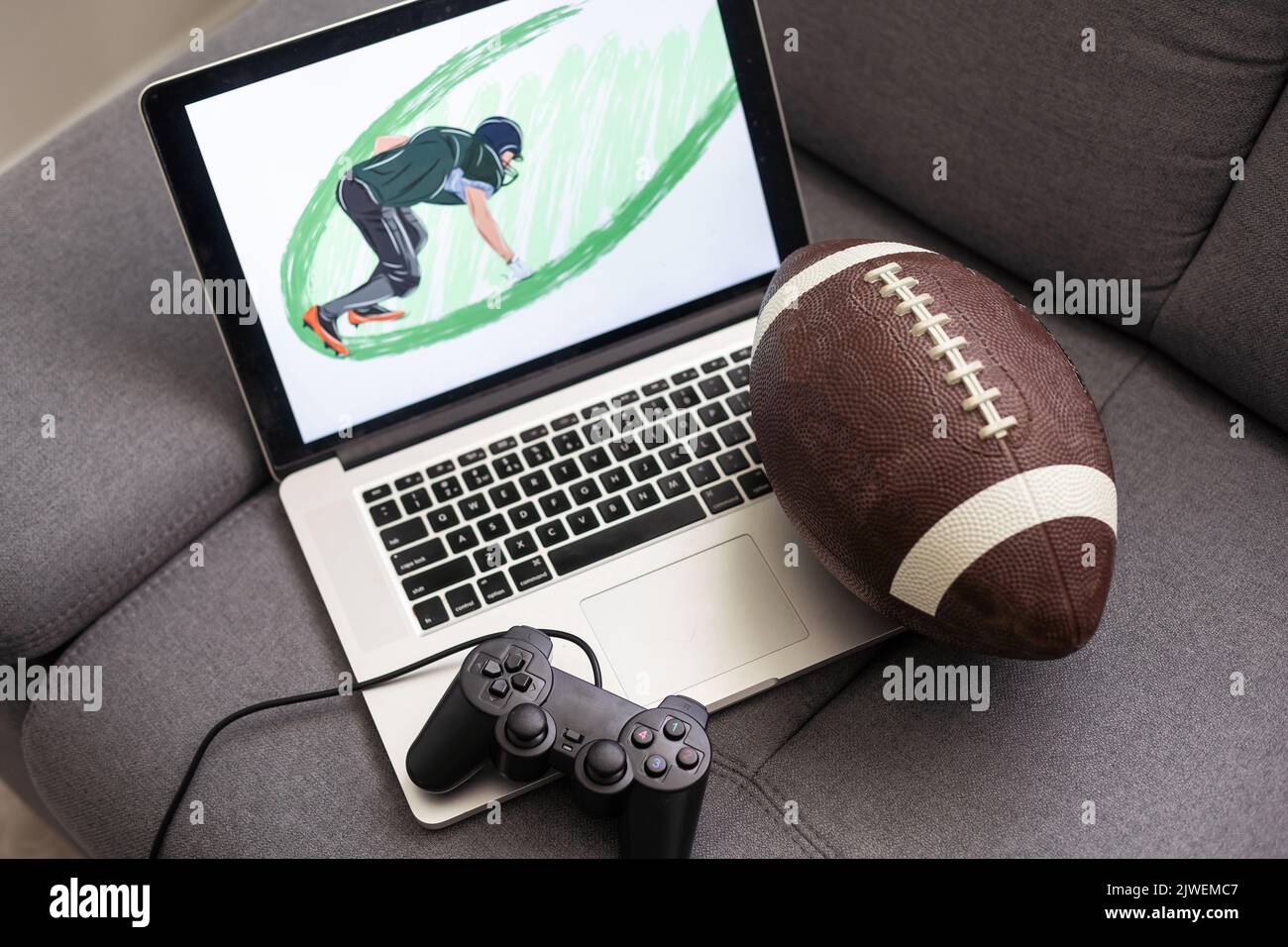 American football ball and game with joystick console Stock Photo - Alamy