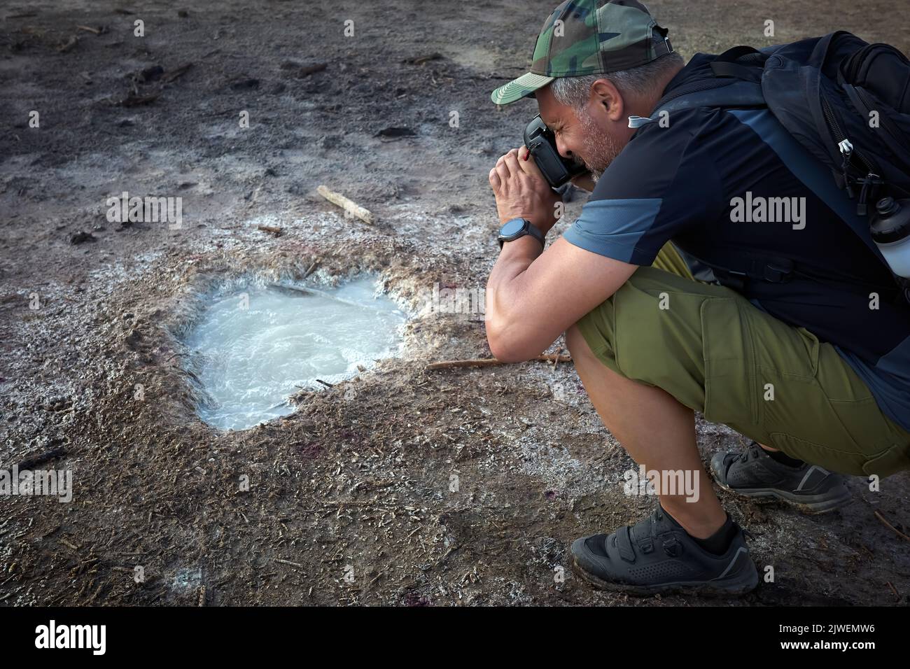 Hiker visits the caldera, a small circular crater with a marsh of ...