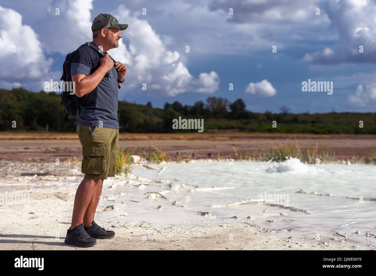 Hiker visits the caldera, a small circular crater with a marsh of ...
