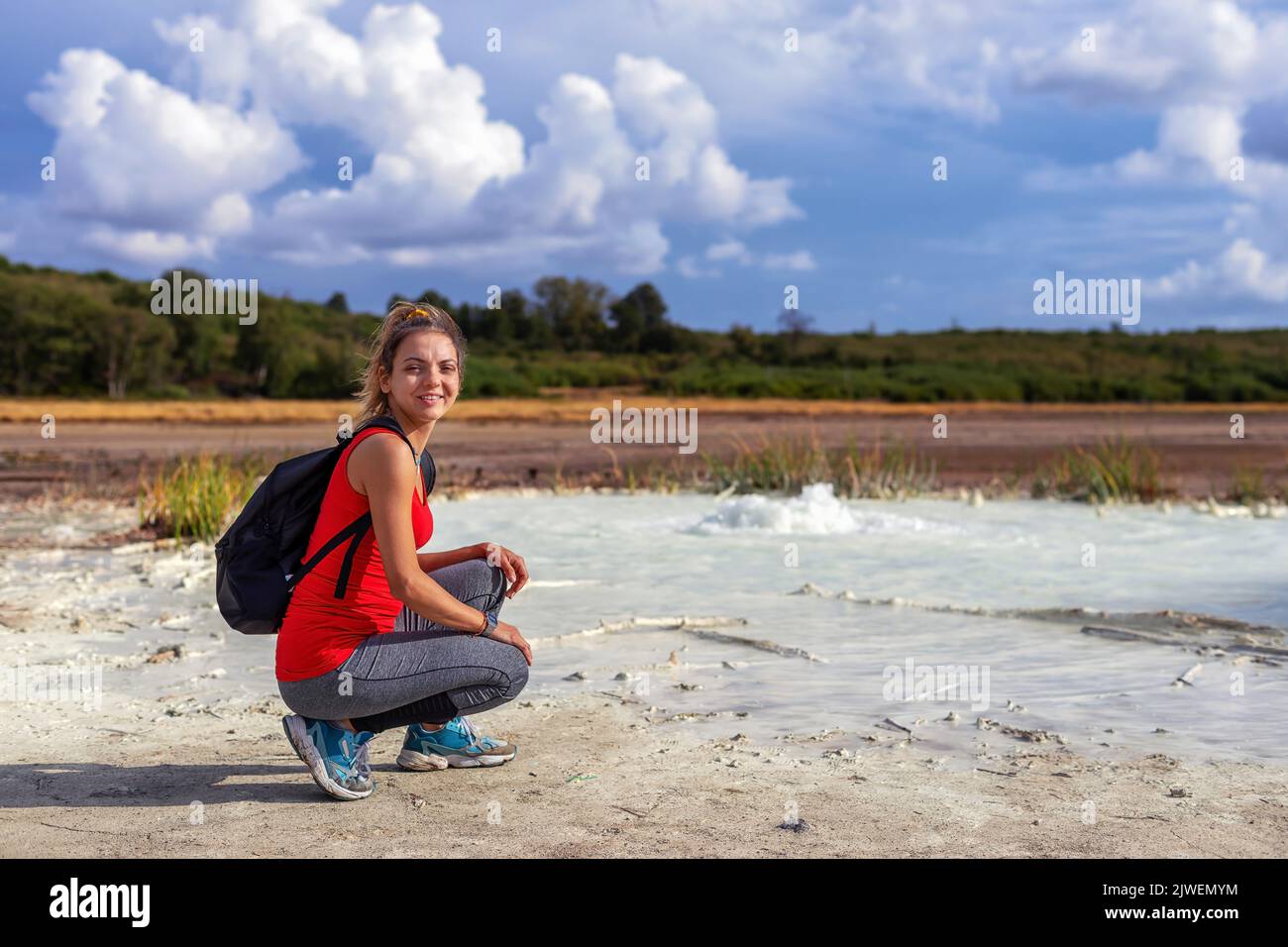 Hiker visits the caldera, a small circular crater with a marsh of ...