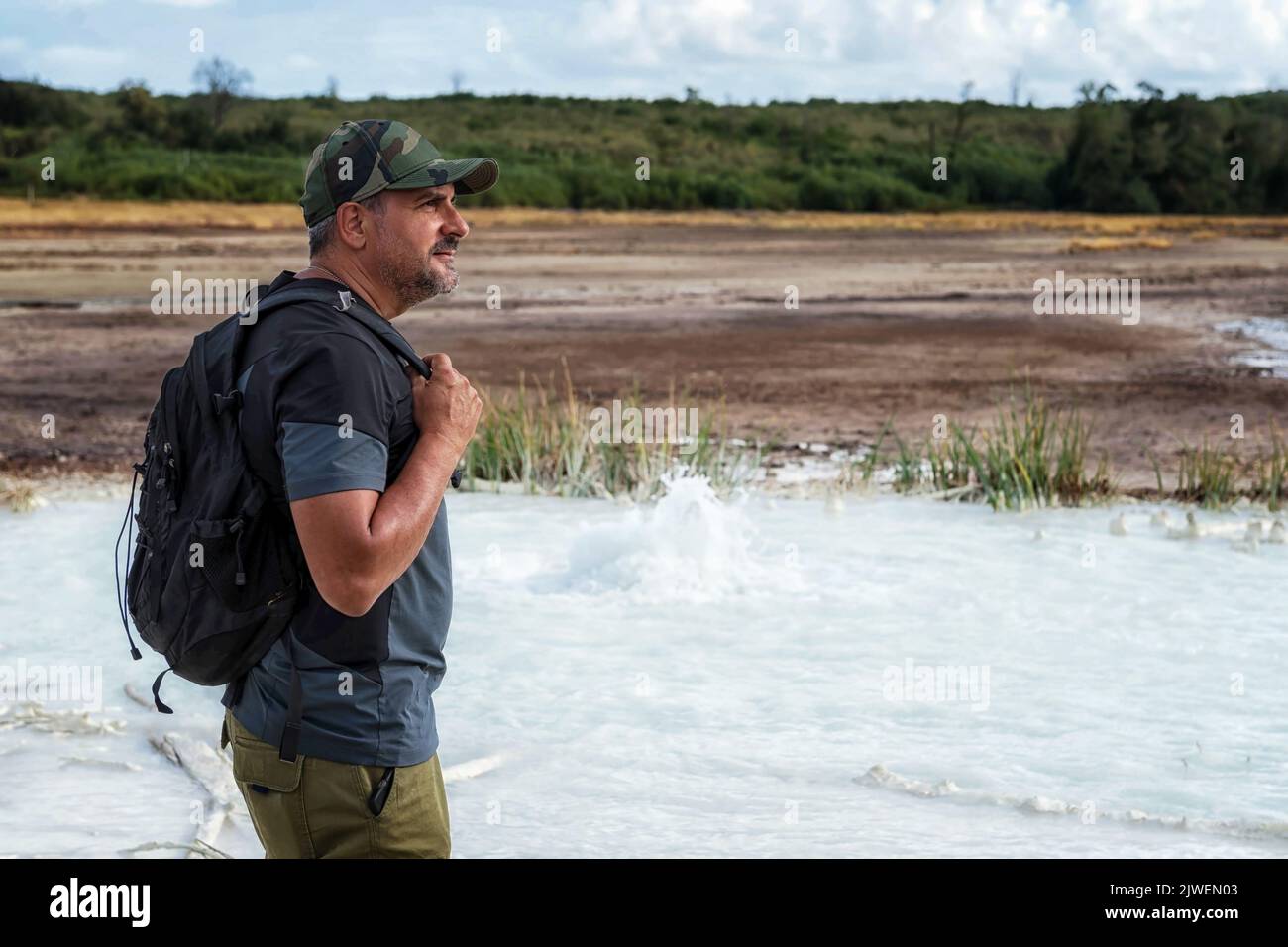 Hiker visits the caldera, a small circular crater with a marsh of ...