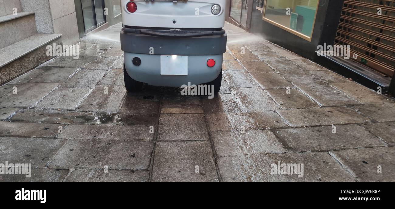 Street washer vehicle cleaning downtown pavement. Long format Stock ...