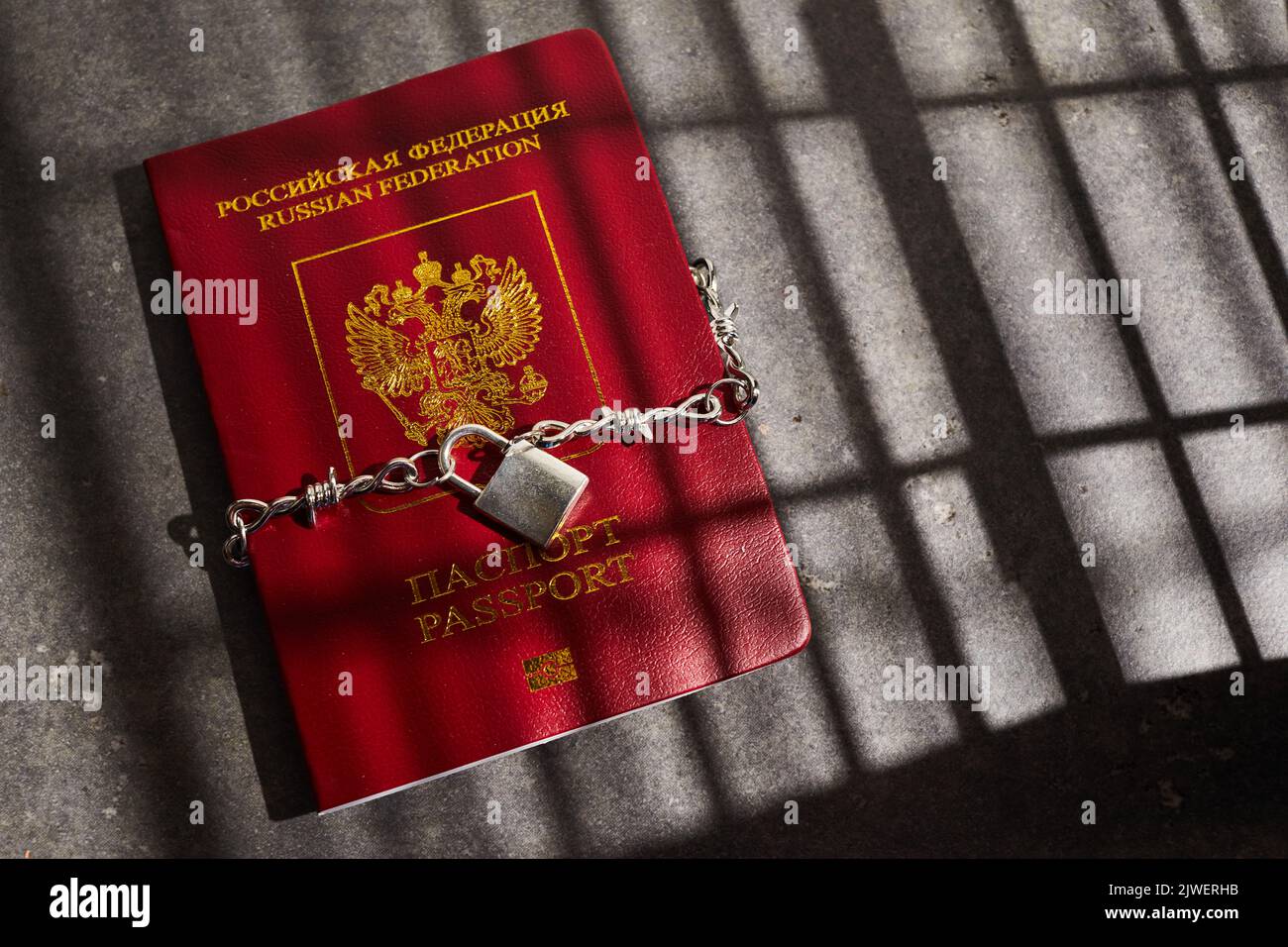 Russian passport chained in a chain with a padlock is located ...