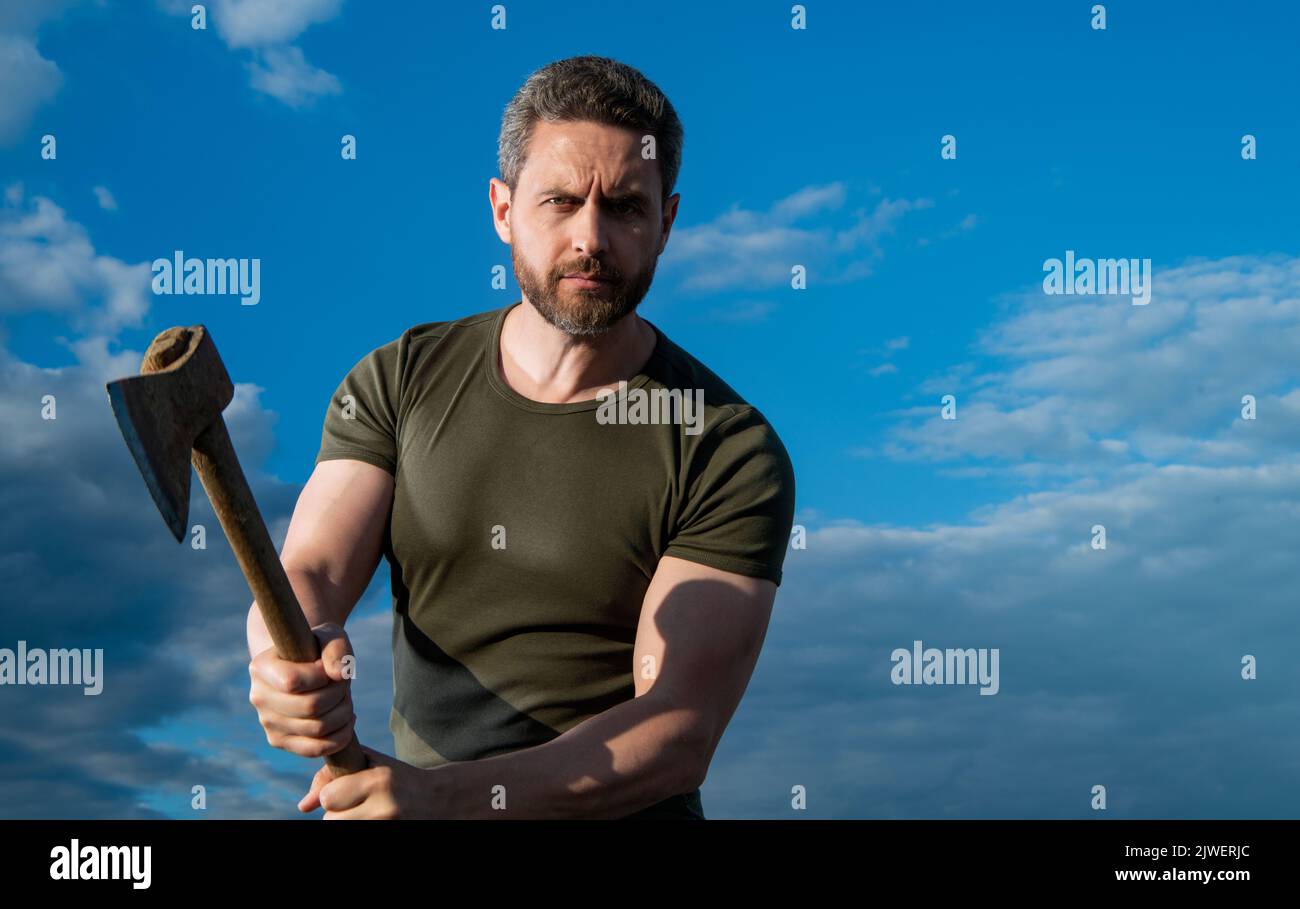 man hitting with axe. caucasian man hold ax. brutal man on sky ...