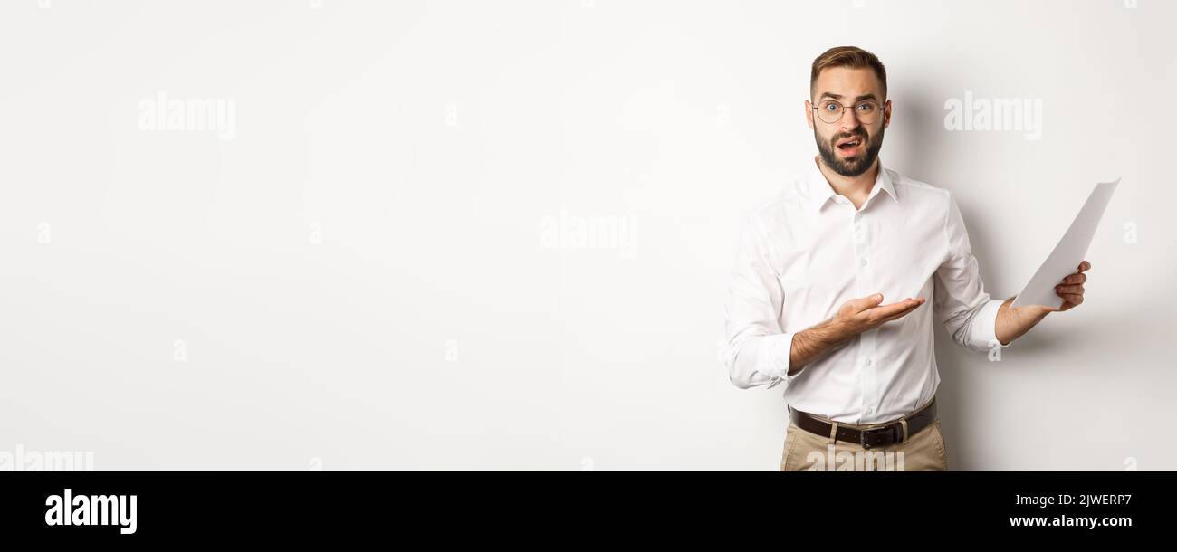 Disappointed boss scolding for bad report, pointing at documents and ...