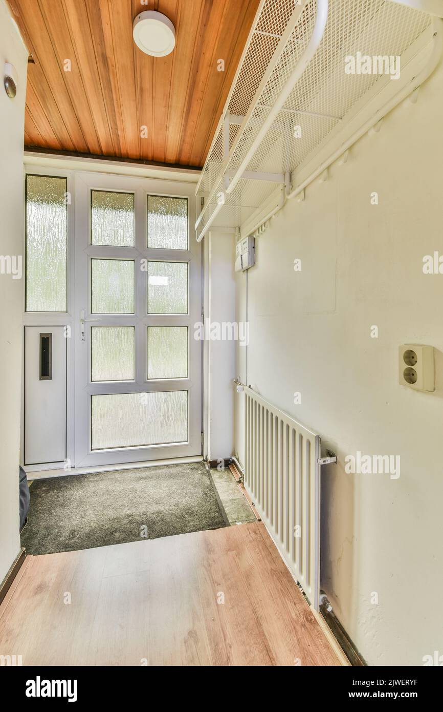 Room with door to terrace and narrow long corridor in perspective in ...
