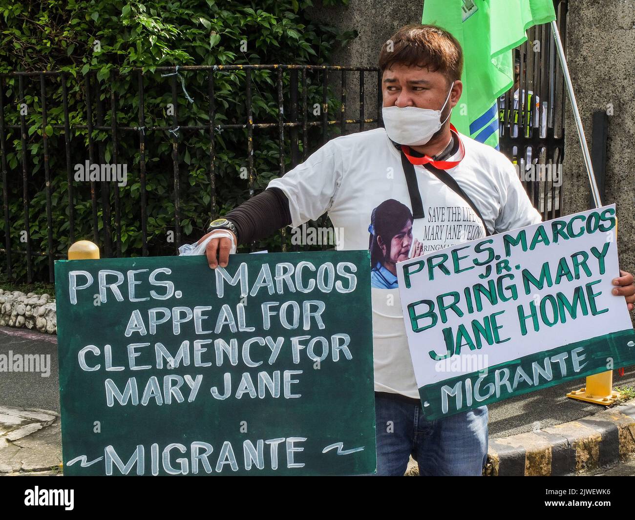 A protester holds placards during a prayer rally at Department of ...