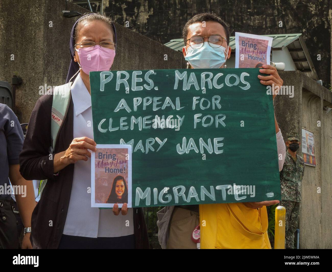 Protesters hold a placard during the prayer rally at Department of ...