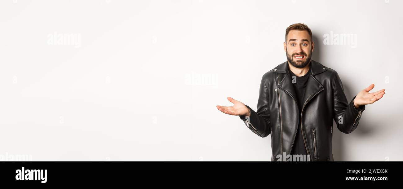 Confused bearded man in black leather jacket asking for advice, looking ...