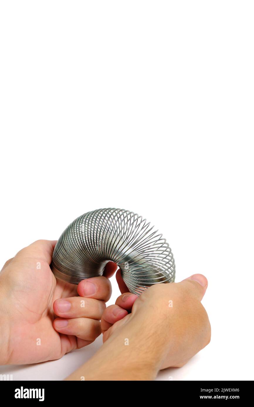 Metal spring antistress toy,slinky, in hand white background Stock ...