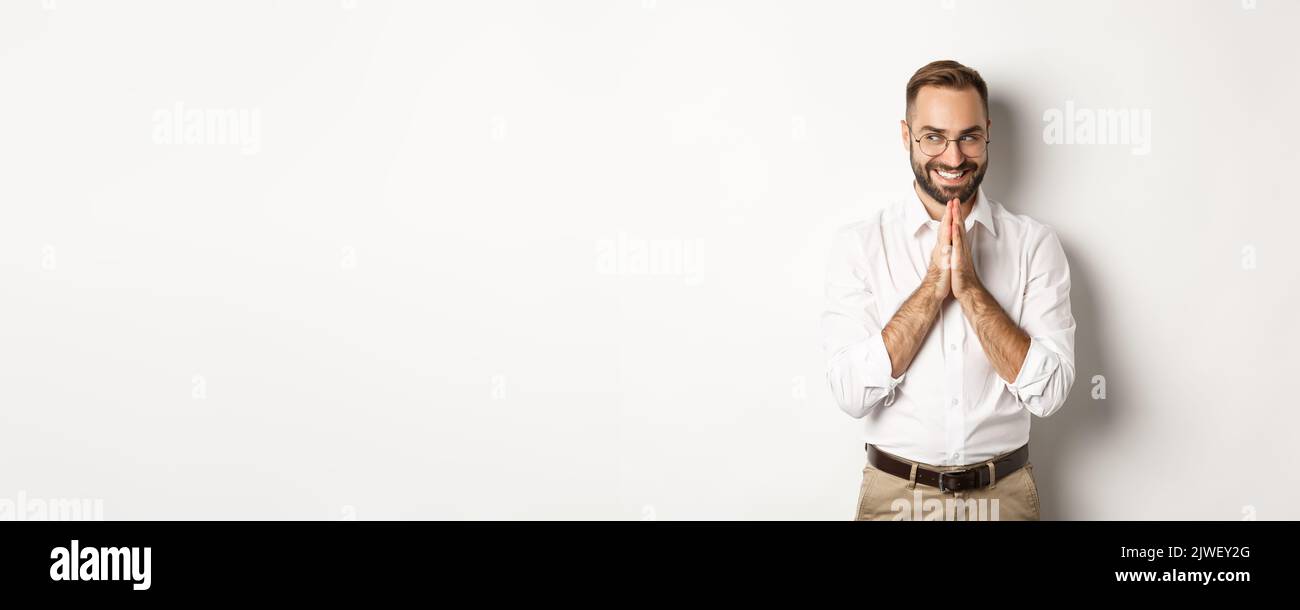 Sly and satisfied man having an idea, rubbing hands and scheming ...