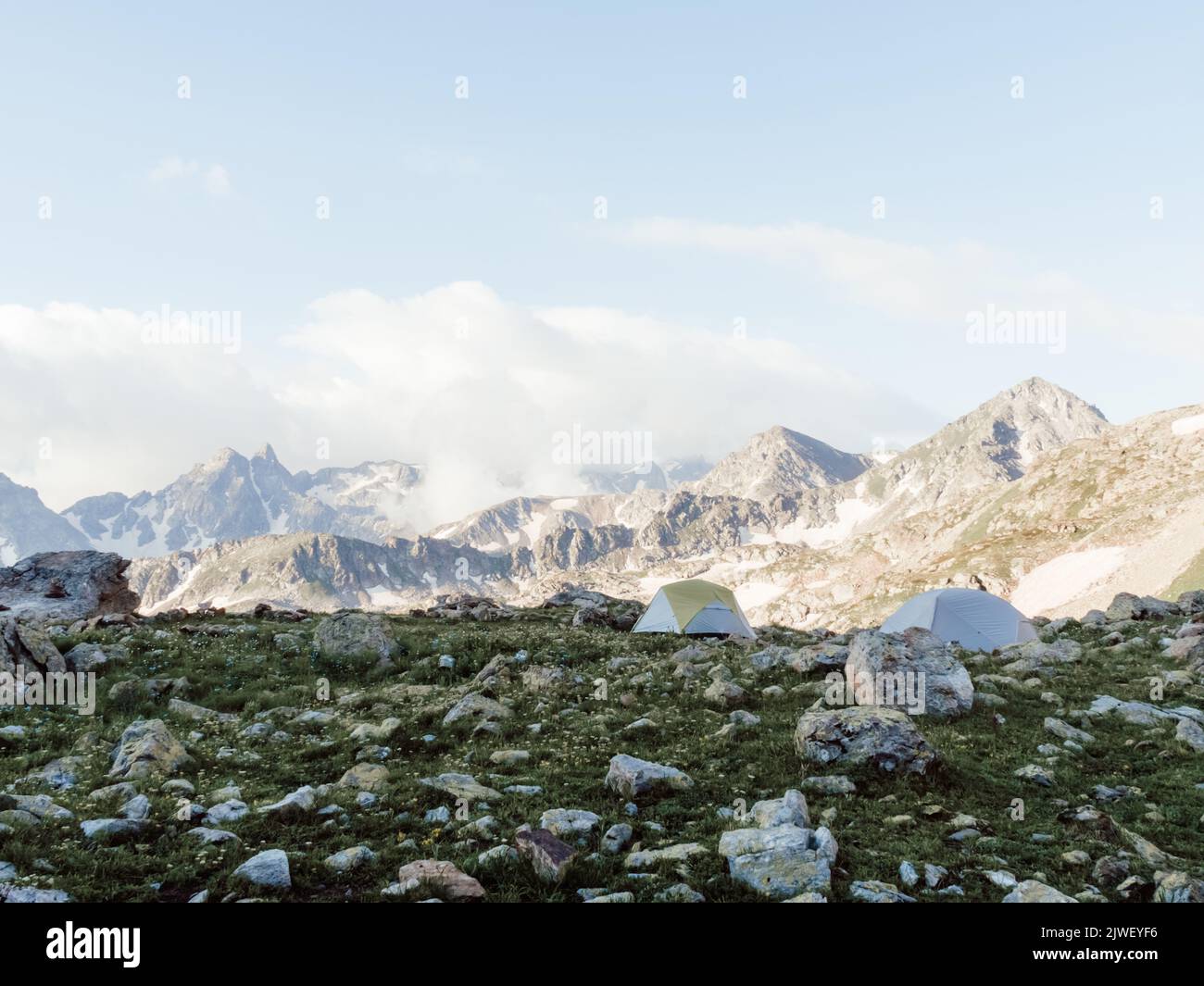 Camping tents with rock and stone mountains background. Mountain ...
