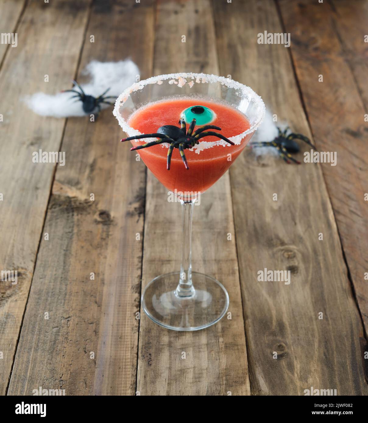 Terrifying red cocktail with spider on wooden background for Halloween ...