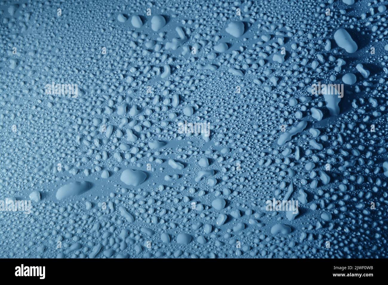 Blue drops of water, dew on smooth surface Stock Photo - Alamy