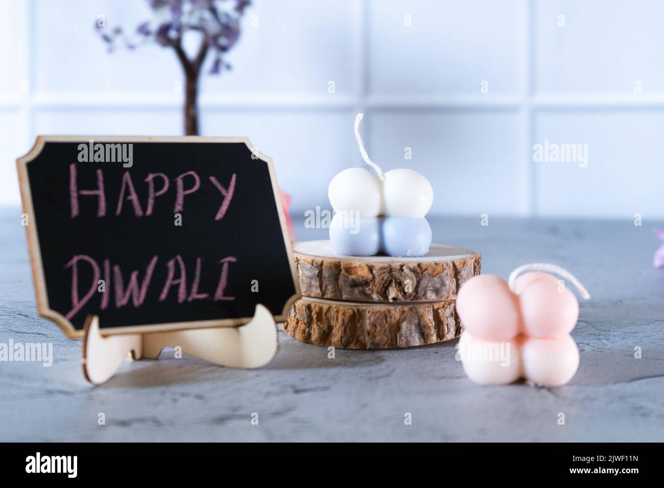 small bubble candles and blackboard with happy diwali written in chalk ...
