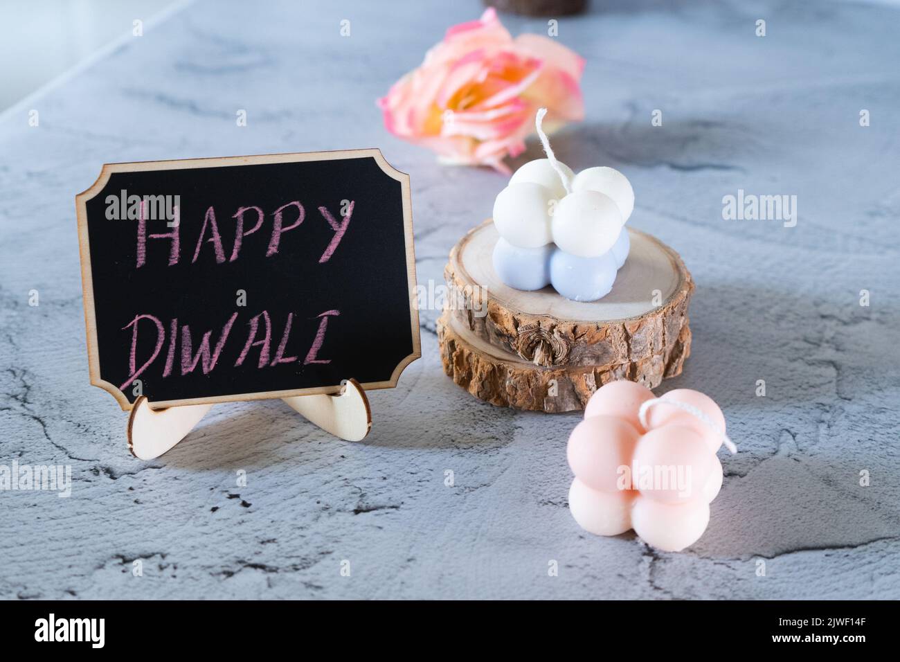 small bubble candles and blackboard with happy diwali written in chalk ...