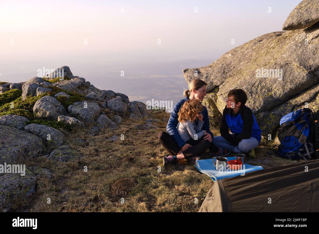 A Mother speaking with kids on campsite Stock Photo - Alamy