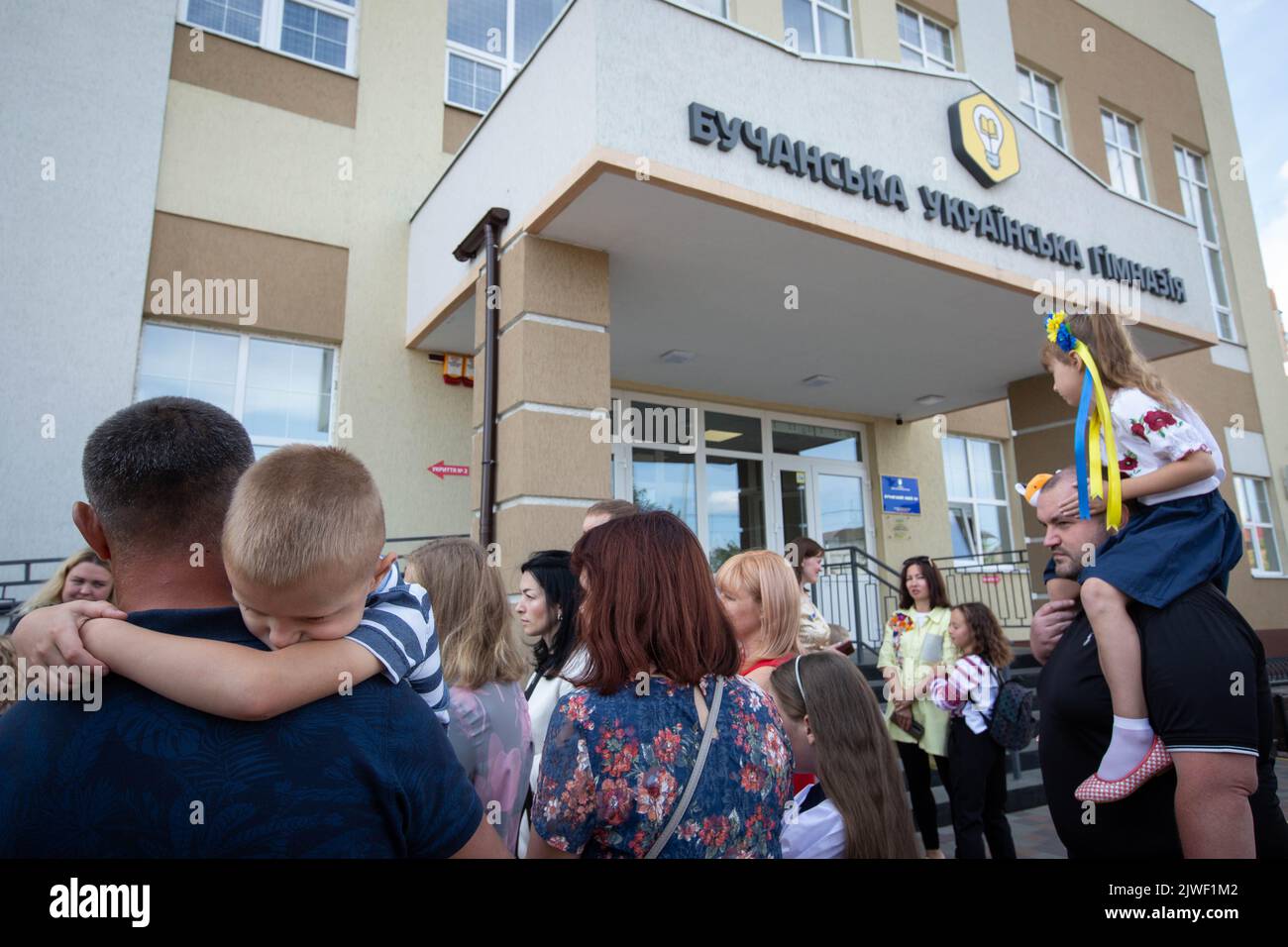 Bucha, Ukraine. 1st Sep, 2022. A pupil sits on the father's shoulders ...