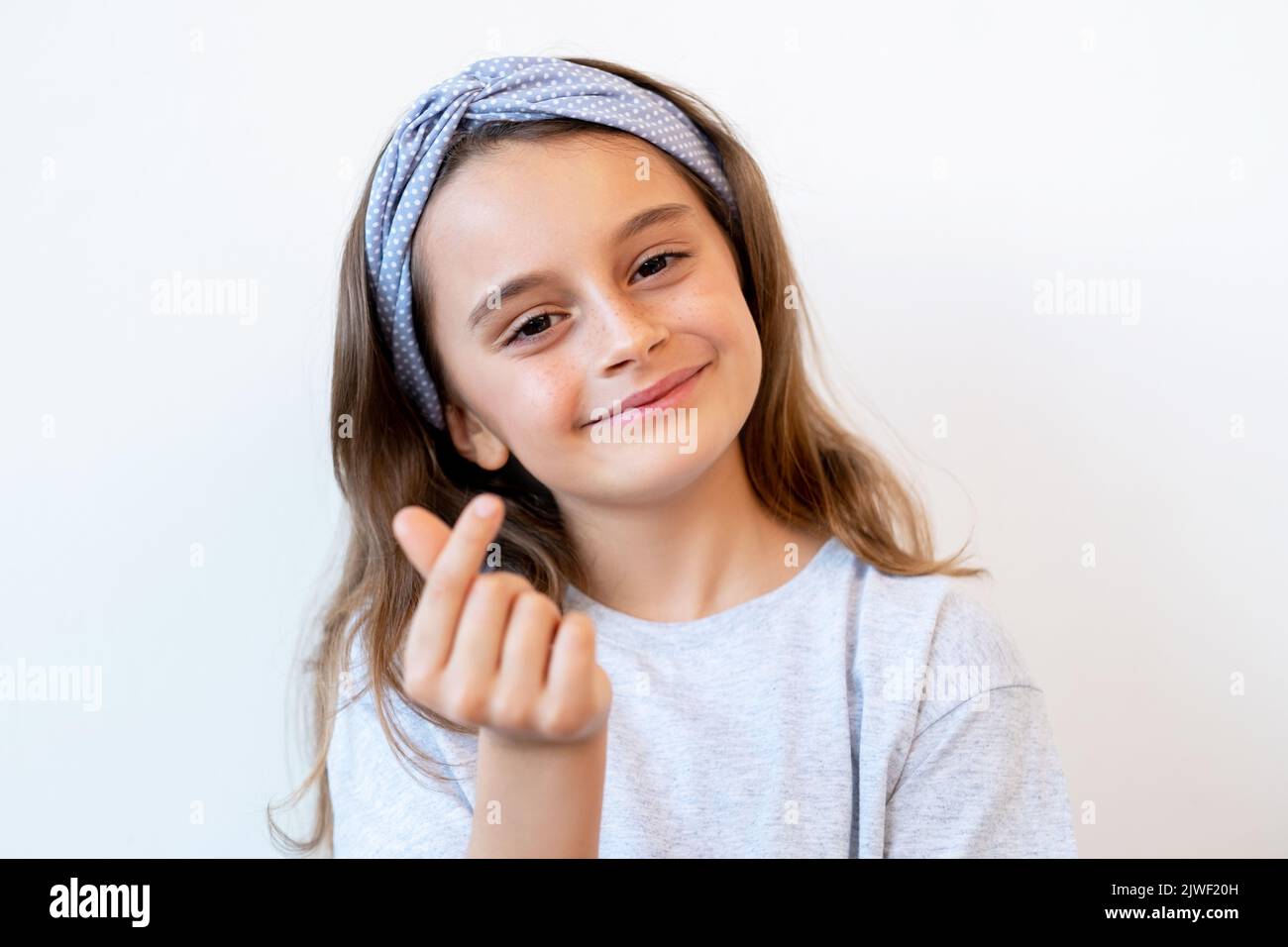 supportive child cute girl finger heart gesture Stock Photo - Alamy