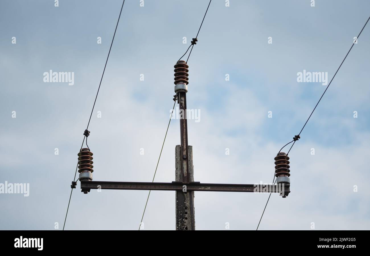 Old electric poles with stretched cables. Old electrical network ...