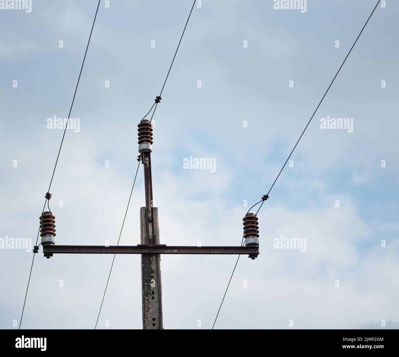 Old electric poles with stretched cables. Old electrical network ...