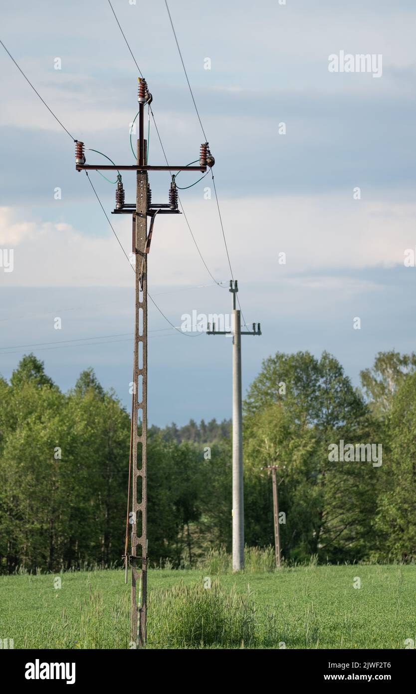 Old electric poles with stretched cables. Old electrical network ...