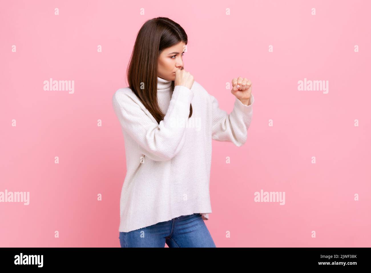 Side view portrait of angry female with clenched fists, fighting with ...