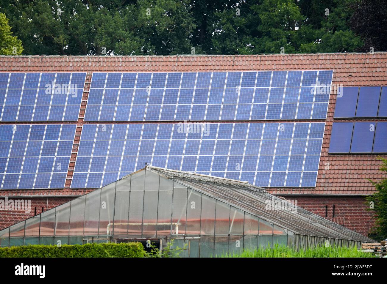 Solar panels on a red brick roof of a building Stock Photo - Alamy