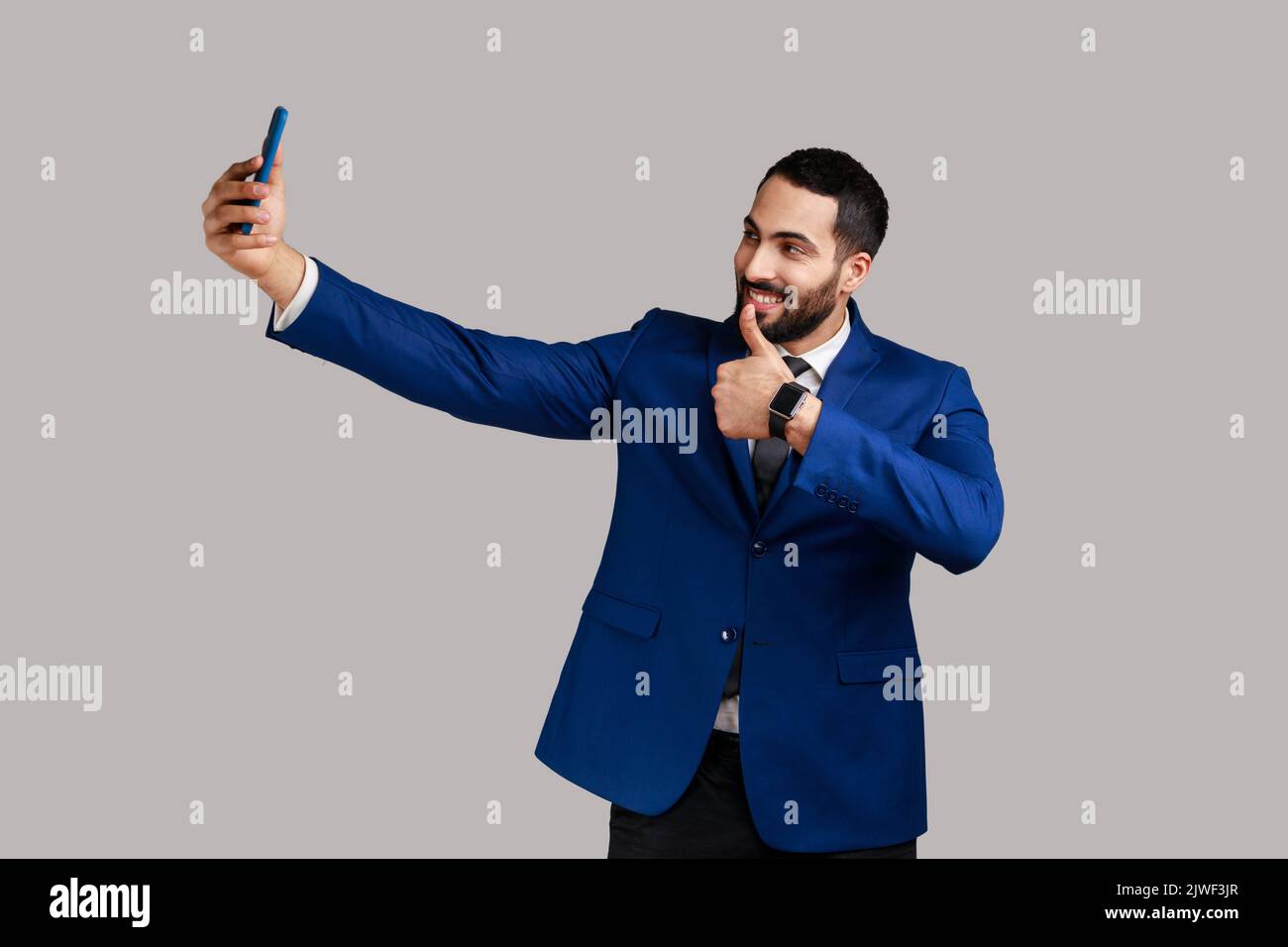 Positive man making selfie on smartphone camera, blogger communicating ...