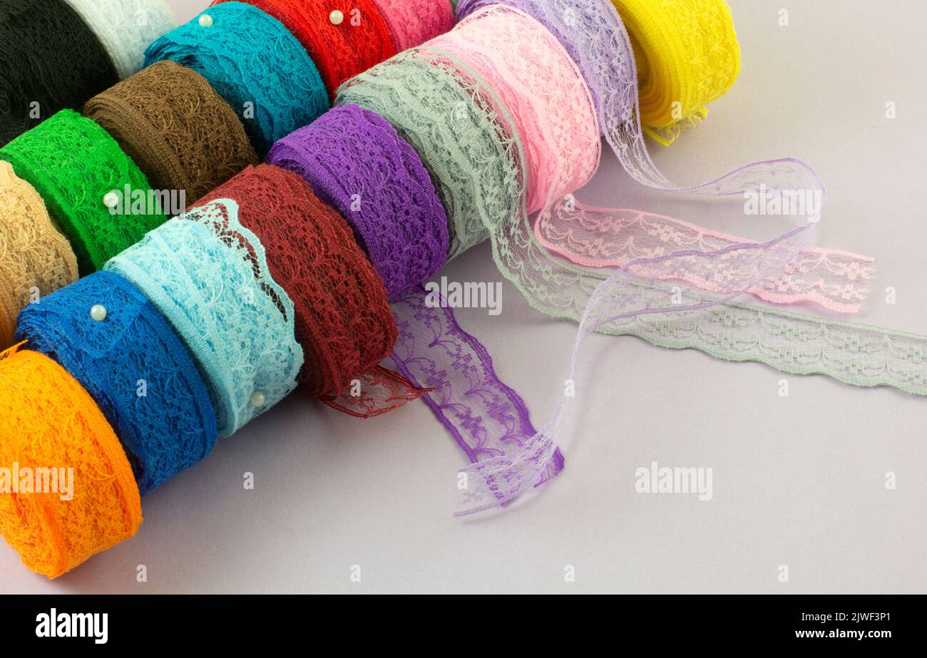 Rolls of lace ribbons in many colors in a row Stock Photo - Alamy