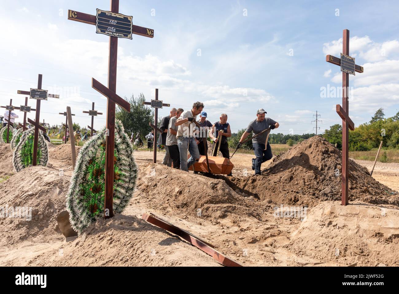 Bucha, Ukraine. 2nd Sep, 2022. A group of men carry a coffin of an ...