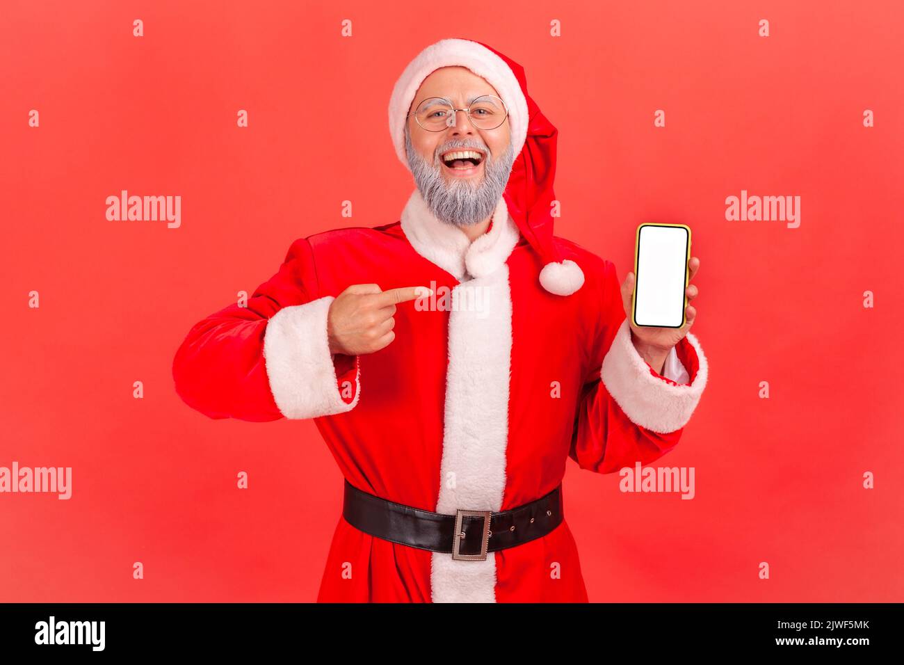 Portrait of excited elderly man with gray beard in santa claus costume ...