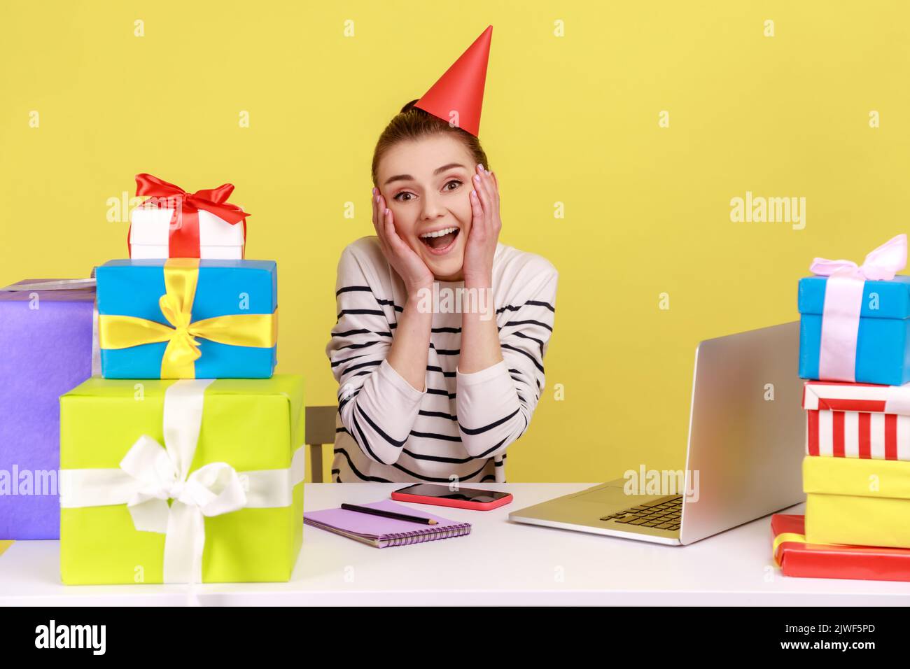 Excited Amazed Woman Secretary Sitting On Workplace Among Present Boxes