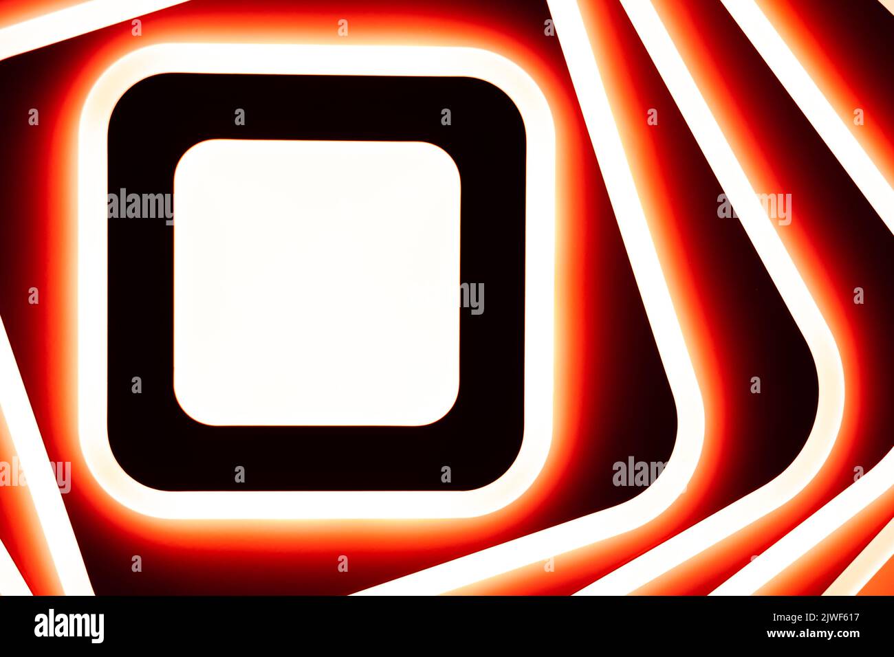 Red-white LED lamp glowing on the ceiling. Technology abstraction ...