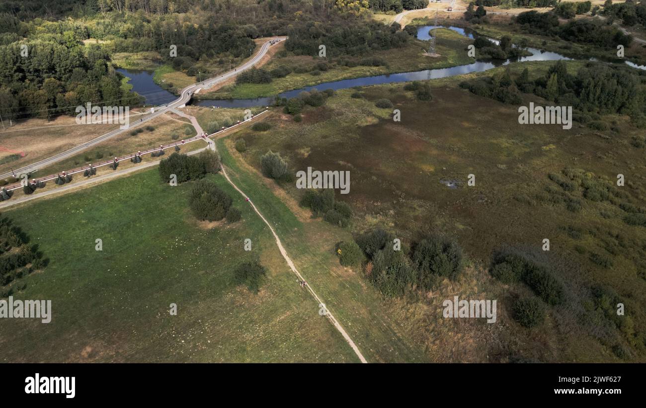 City Park. Pedestrian bridge with bike path across the river. Aerial ...