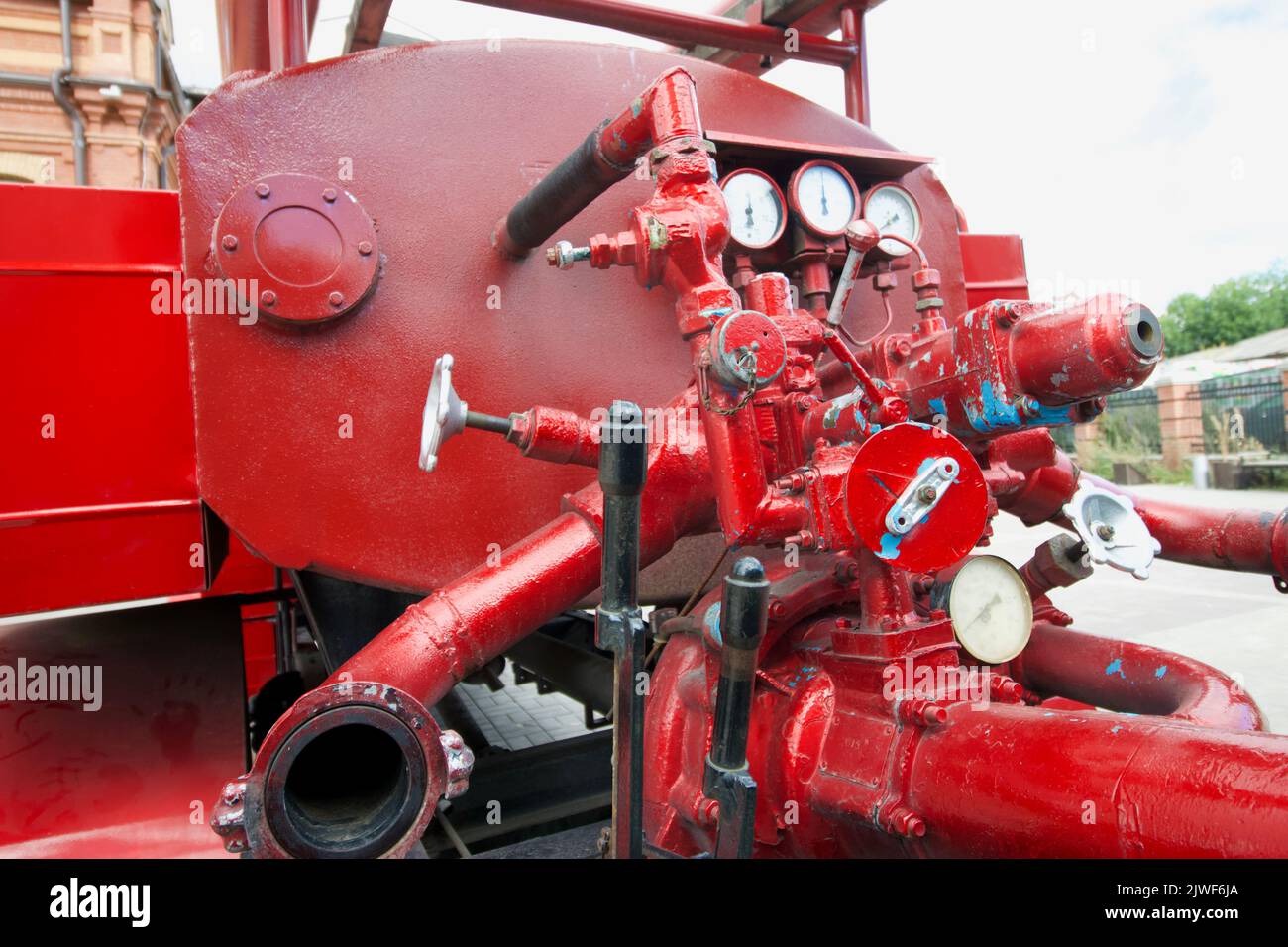Elements of a vintage fire truck. The car is painted red. Close-up ...