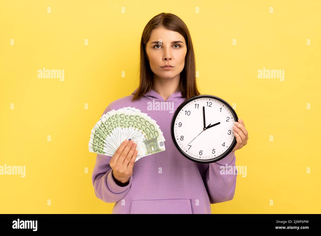 Portrait of rich dark haired woman holding big fan of euro banknotes ...