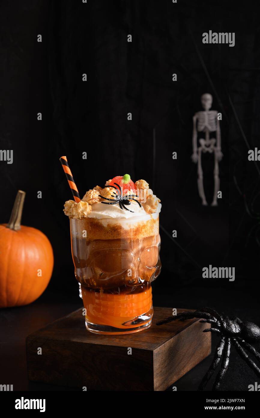Halloween Pumpkin spice coffee latte decorated spider and popcorn in ...