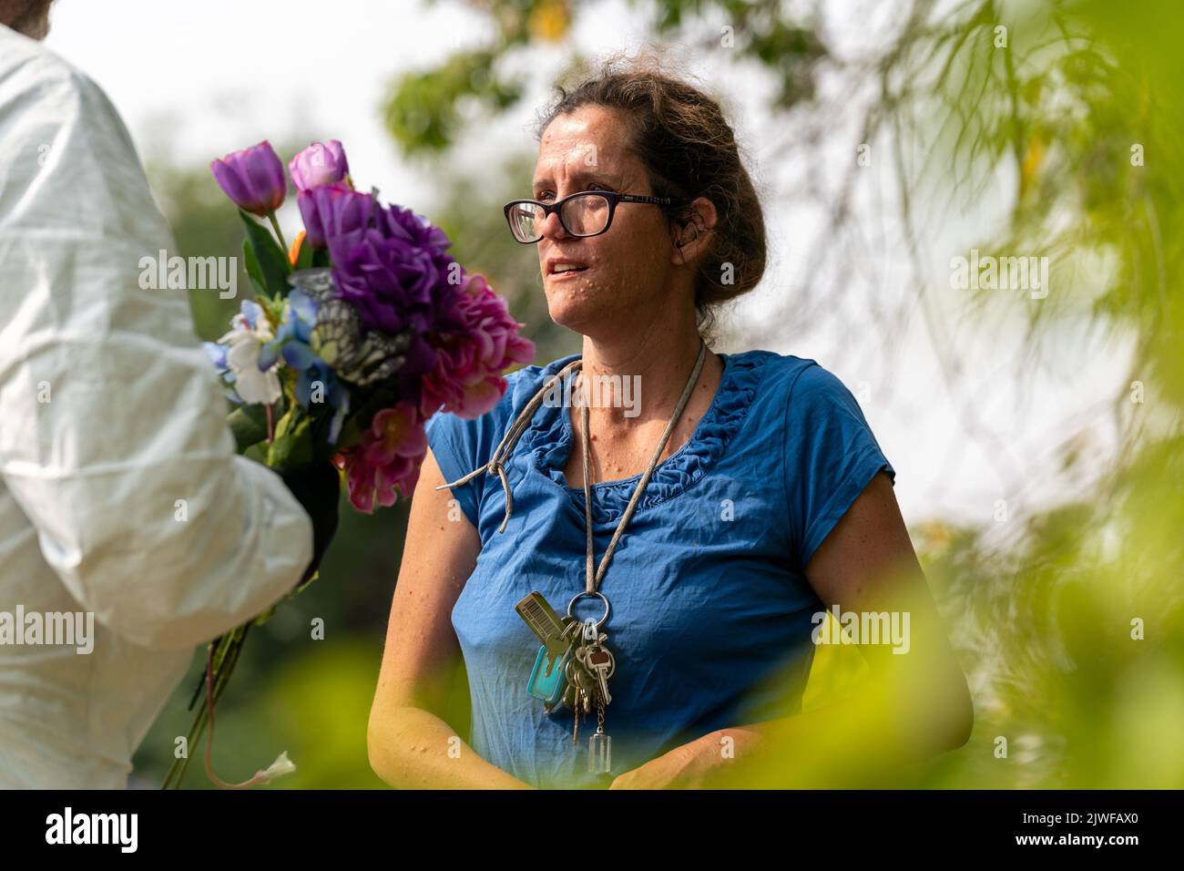 Ruby Works speaks with a forensic investigator before bringing flowers ...