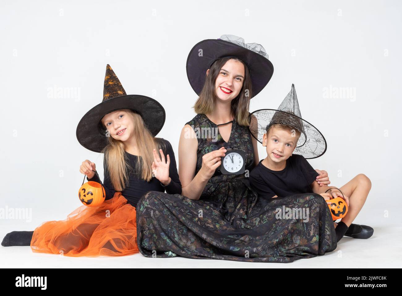 Family Halloween. A happy family, a mother and children in creepy witch ...