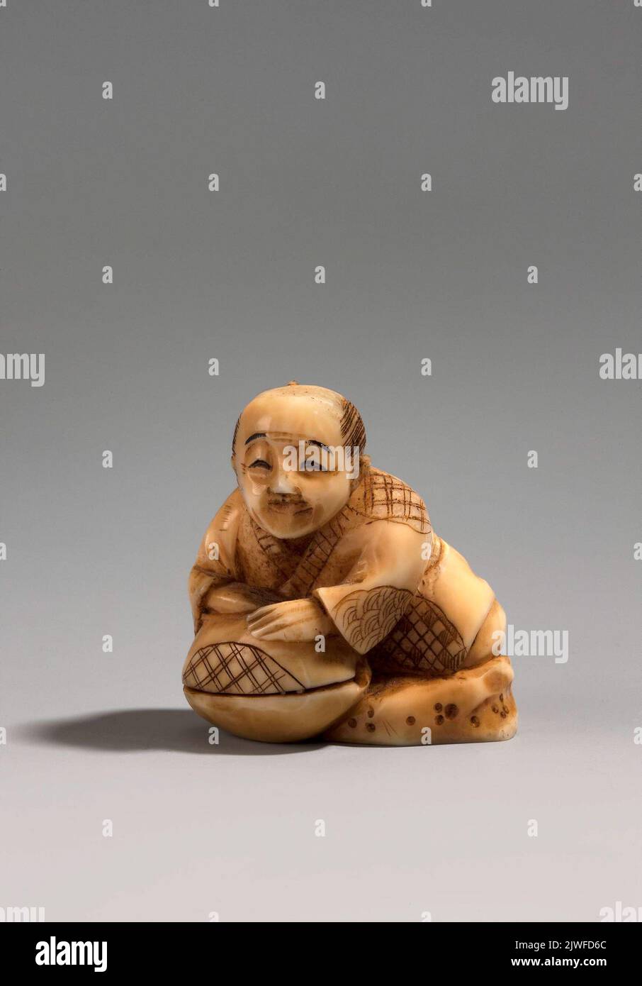 Netsuke in the shape of man squatting by a large container. Kazuyuki ...